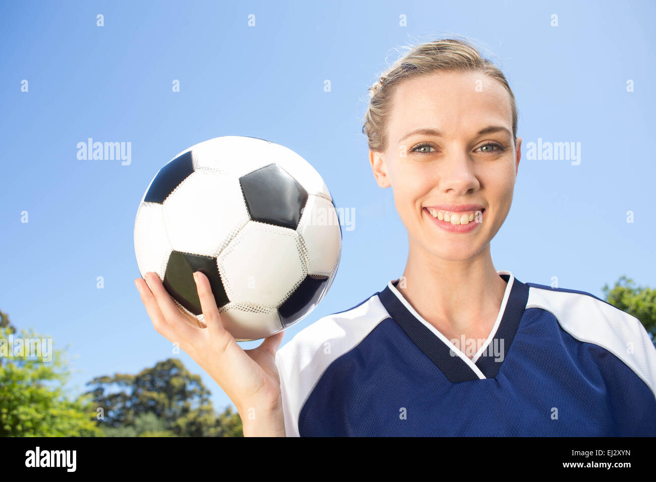 Pretty football player smiling at camera Stock Photo - Alamy