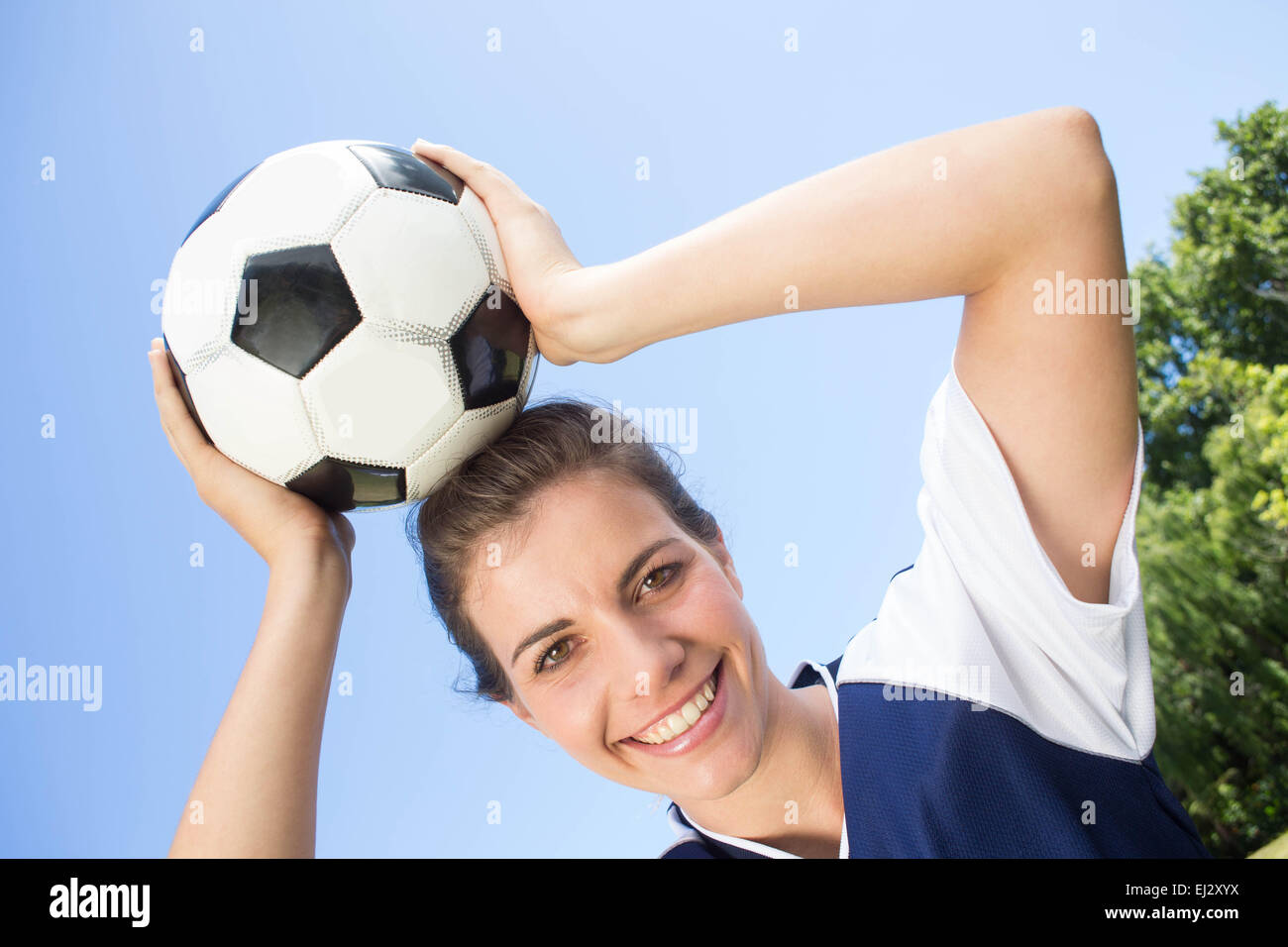 Pretty football player smiling at camera Stock Photo - Alamy