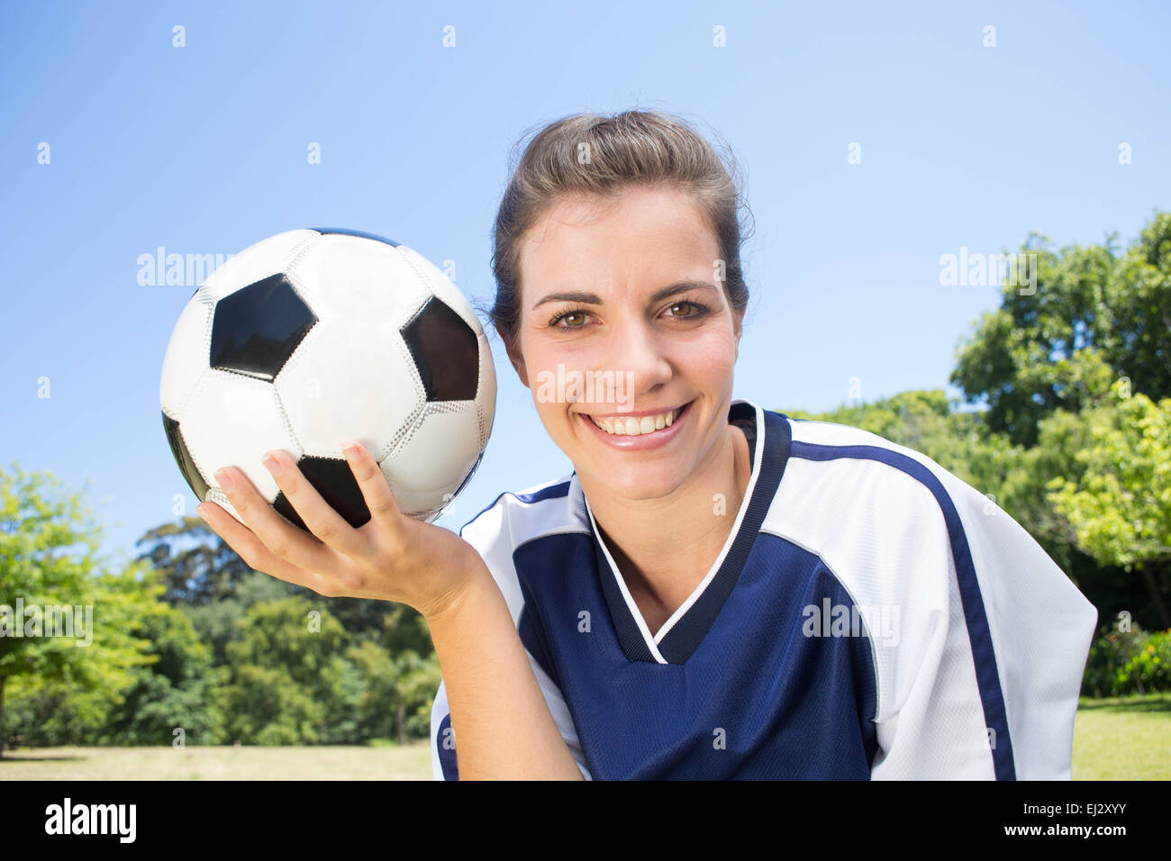 Pretty football player smiling at camera Stock Photo - Alamy