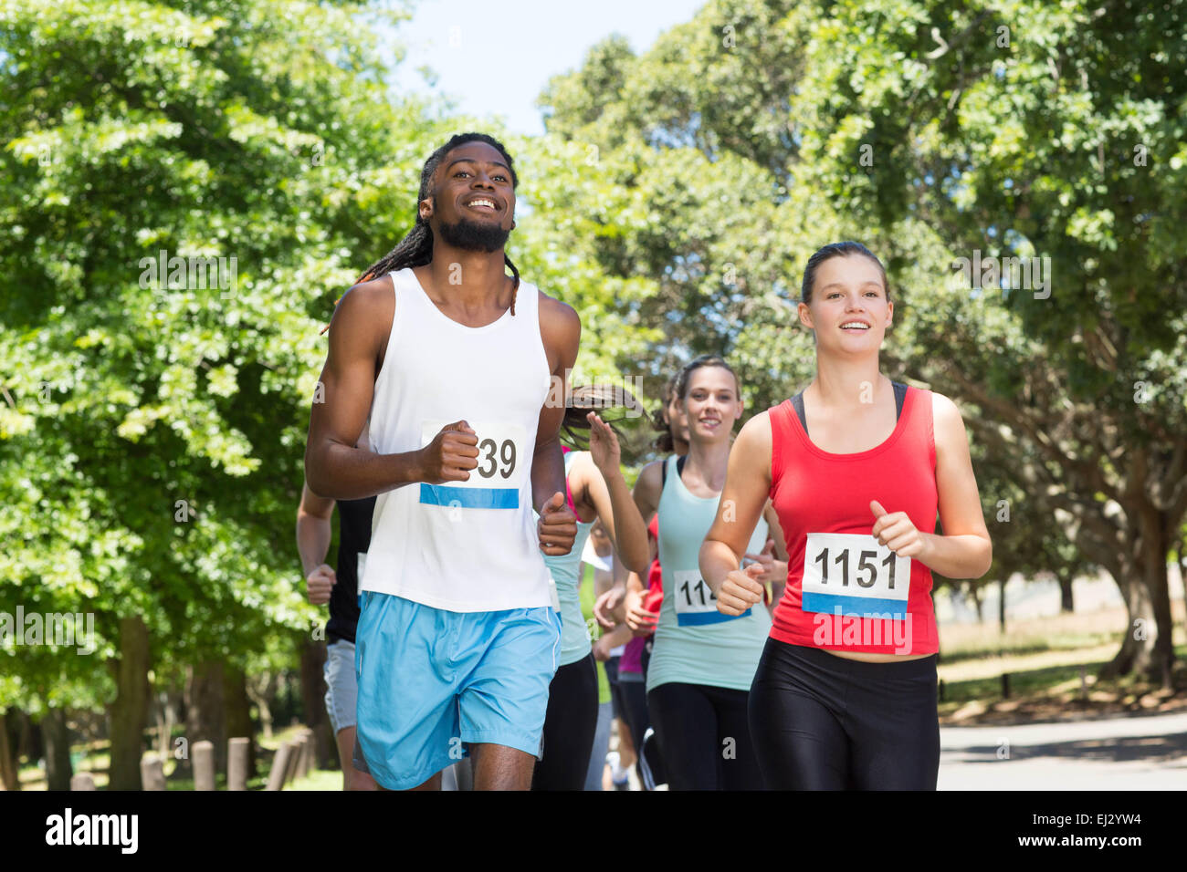 Happy people running race in park Stock Photo - Alamy
