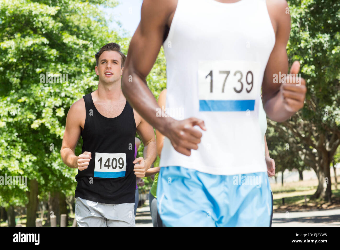 Happy people running race in park Stock Photo - Alamy