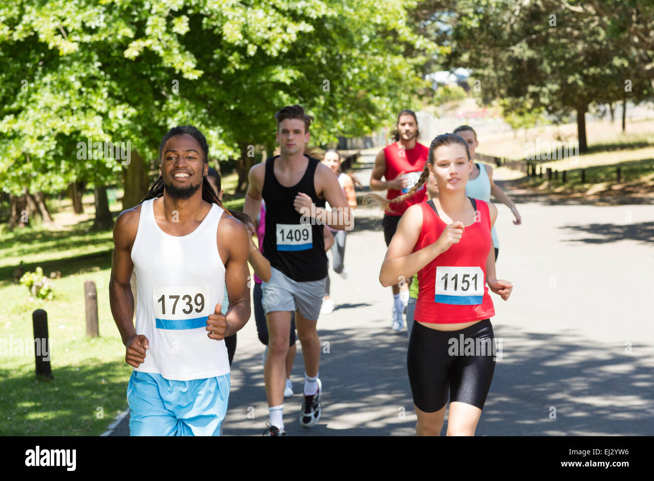 Happy people running race in park Stock Photo - Alamy