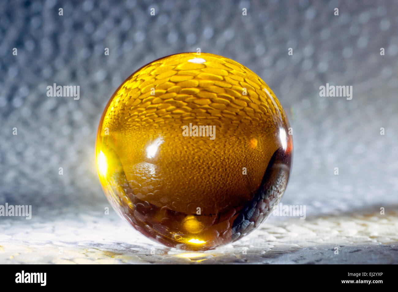 Yellow crystal mineral stone sphere in studio setting Stock Photo - Alamy