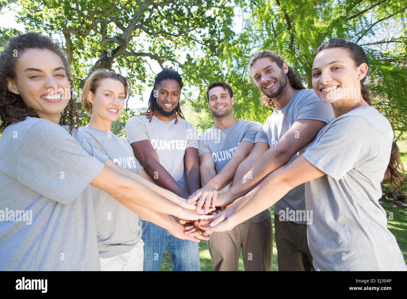 Happy volunteers in the park Stock Photo - Alamy