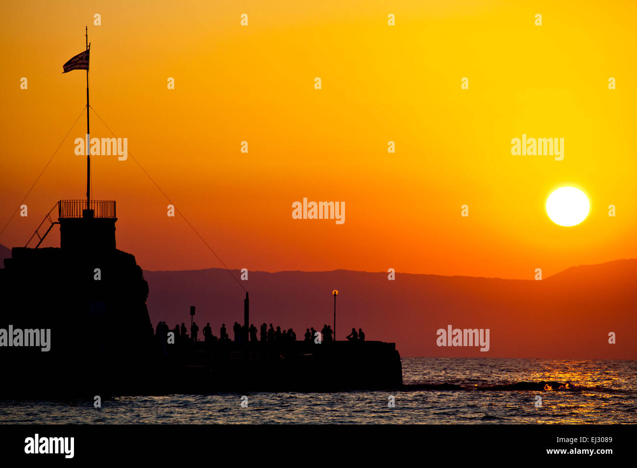 Sunset over Chania port promenade in Chania in Crete, Greece Stock ...