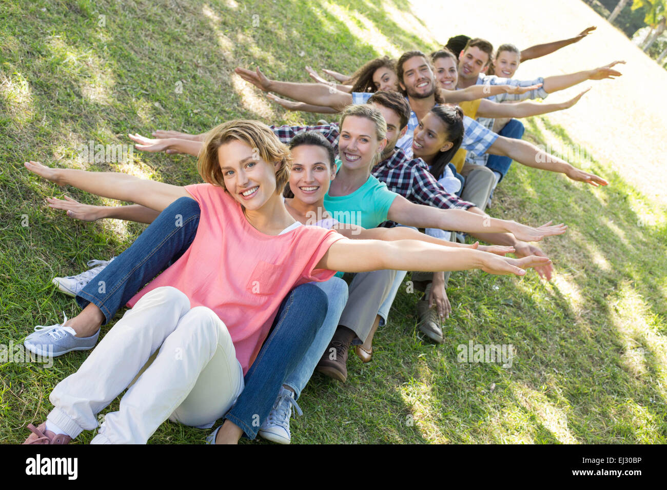 Happy friends in the park playing games Stock Photo - Alamy