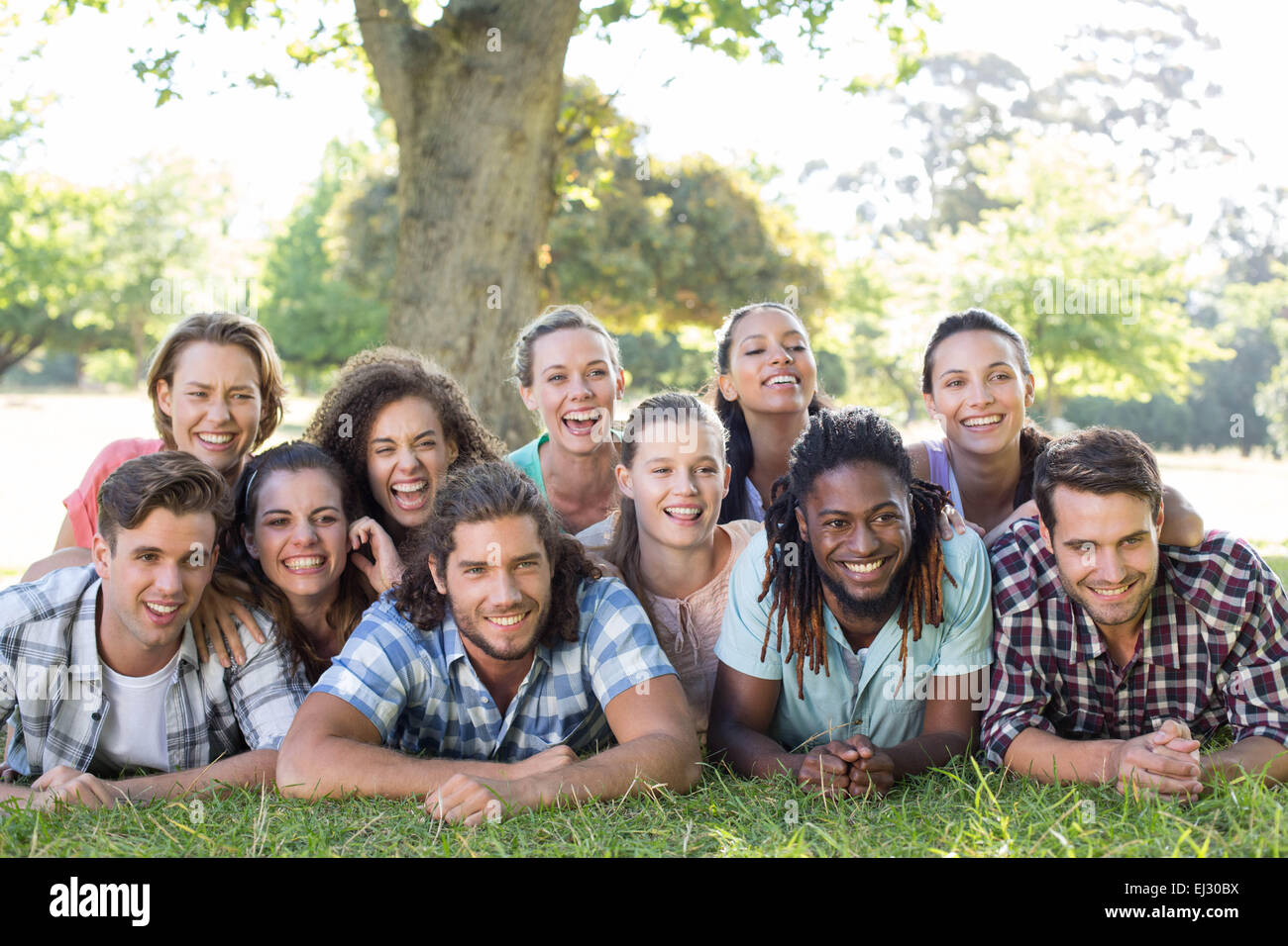 Happy friends in the park Stock Photo - Alamy