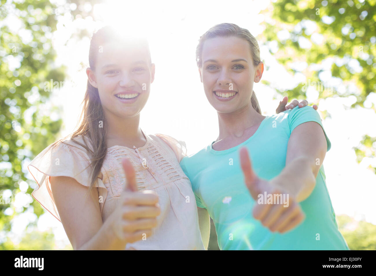 Happy friends smiling in park Stock Photo - Alamy