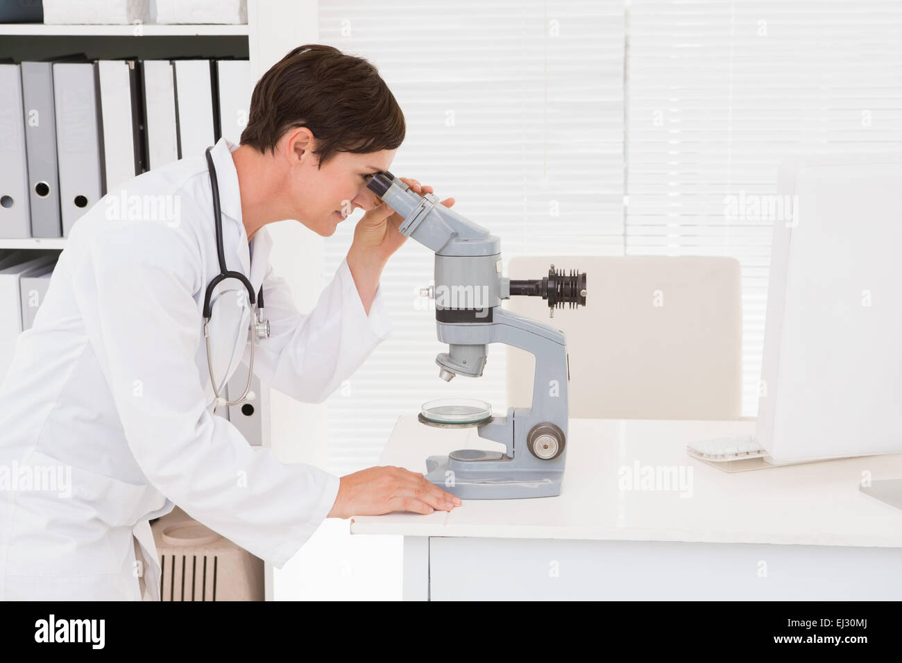 Looking through microscope hi-res stock photography and images - Alamy