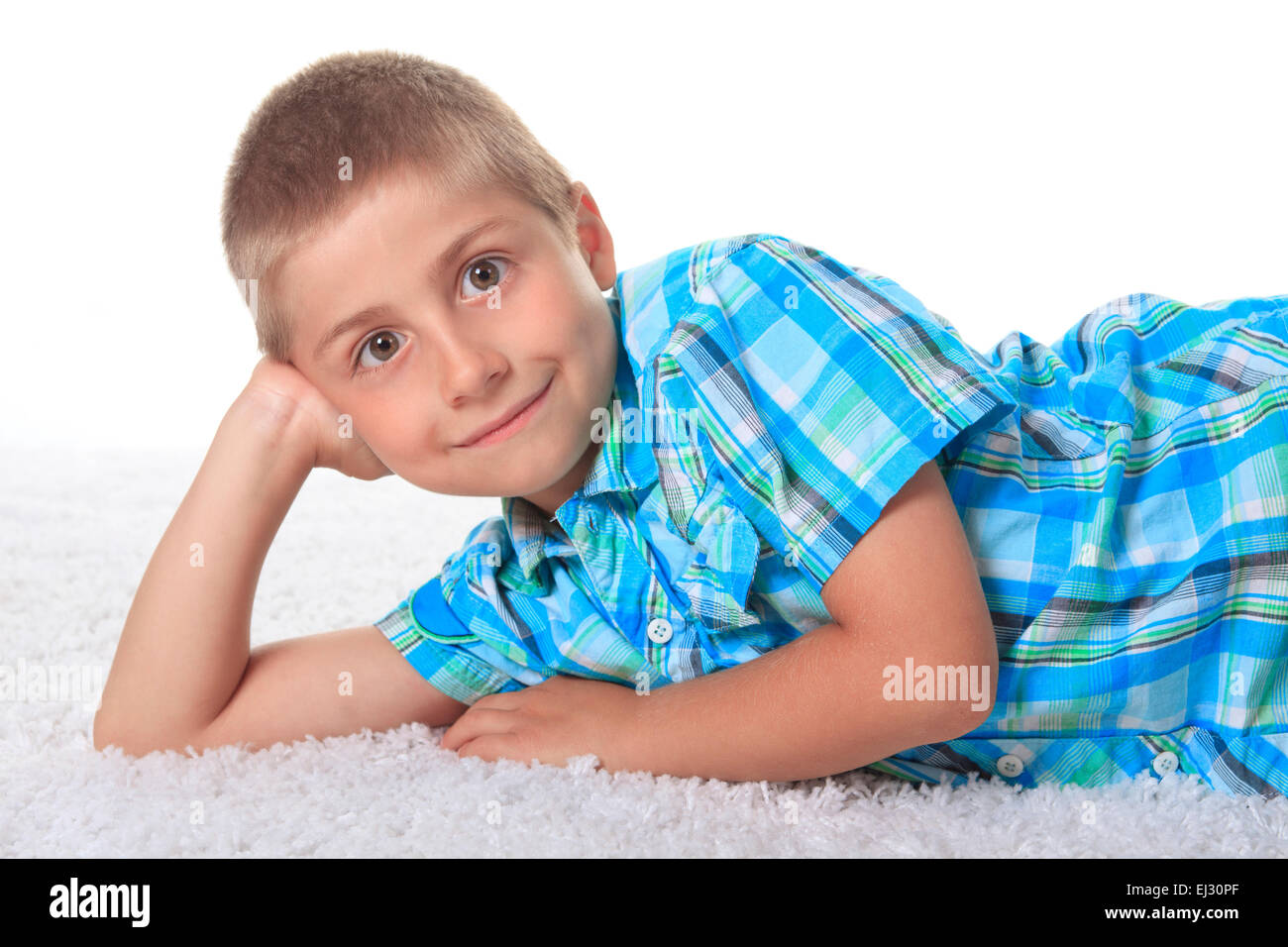 Young Boy Lying in Studio Stock Photo - Alamy