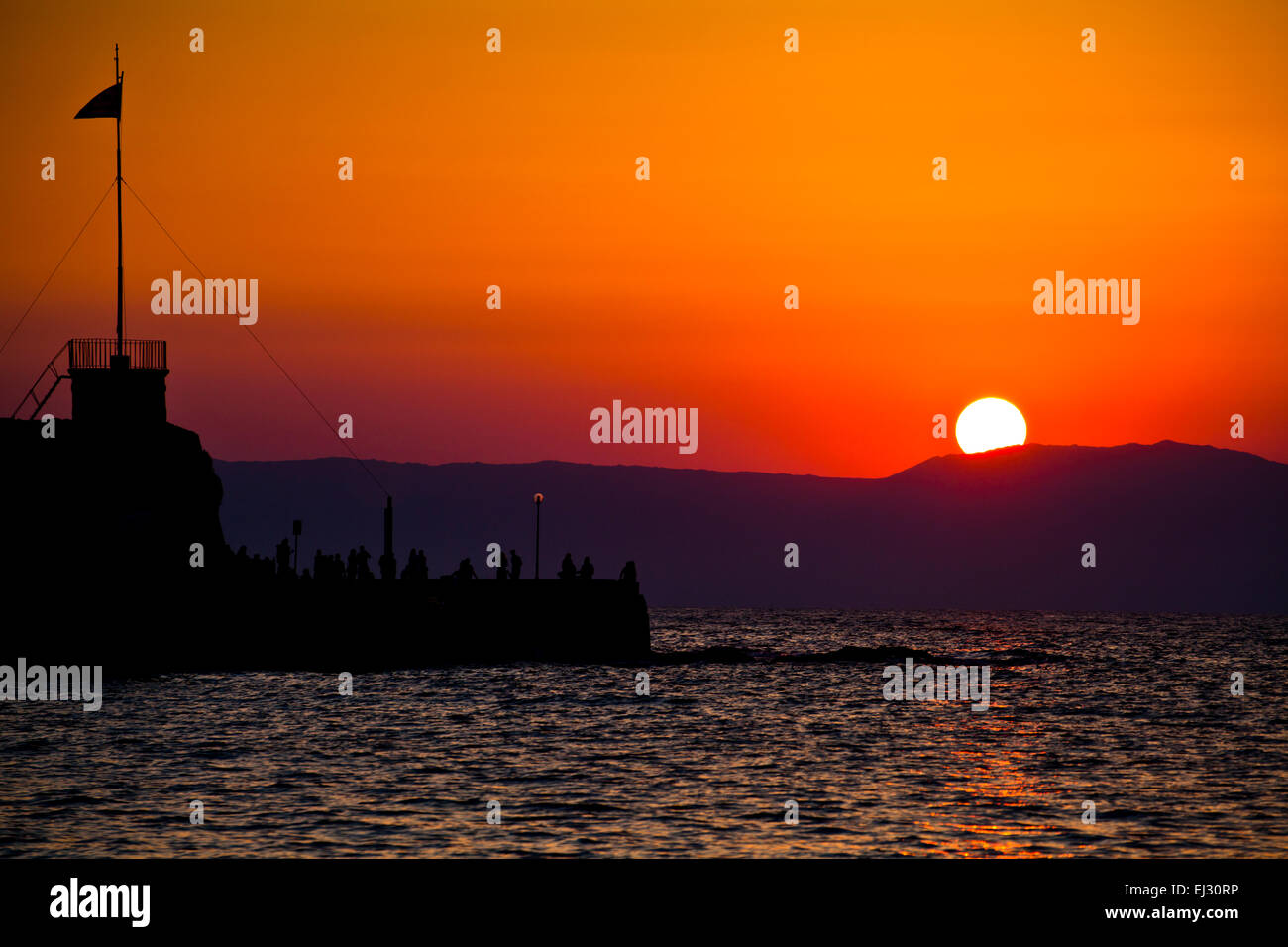 Sunset over Chania port promenade in Chania in Crete, Greece Stock ...