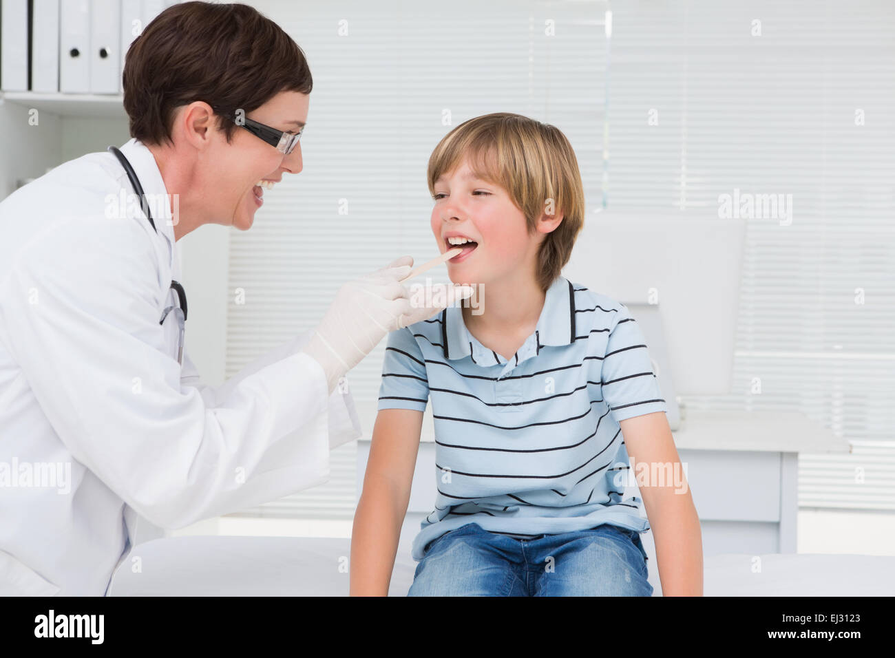 Doctor examining a little boy with stem Stock Photo - Alamy
