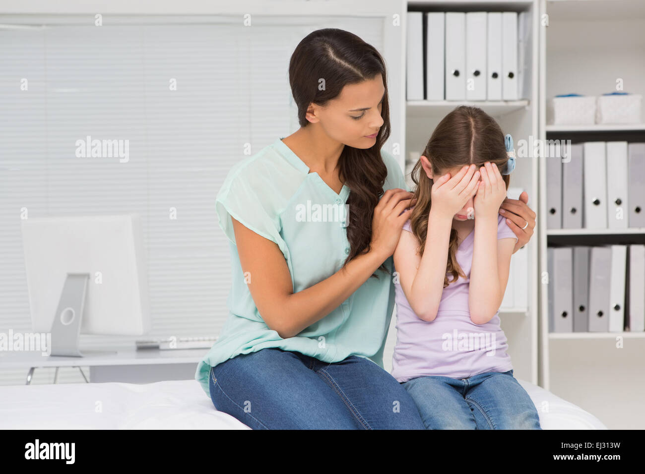 Little girl crying with her mother Stock Photo - Alamy