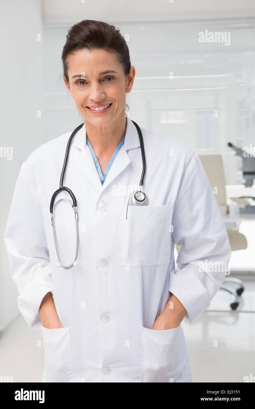 Smiling veterinarian standing with stethoscope Stock Photo - Alamy