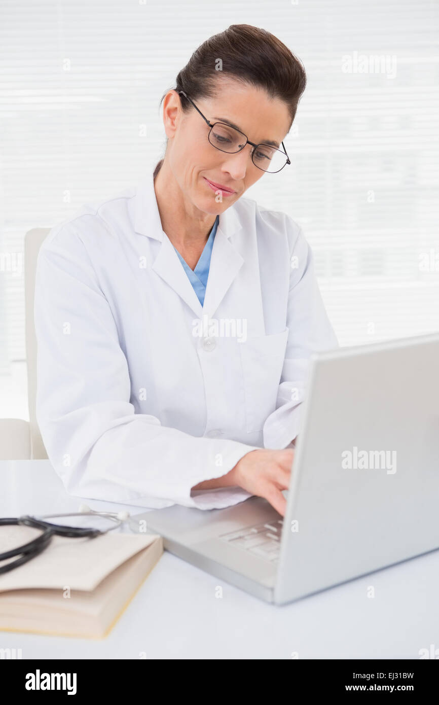 Doctor stethoscope holding laptop typing hi-res stock photography and ...