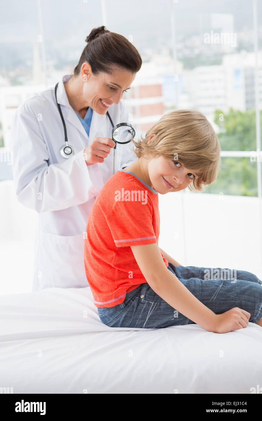 Doctor examining patient with magnifying glass Stock Photo - Alamy