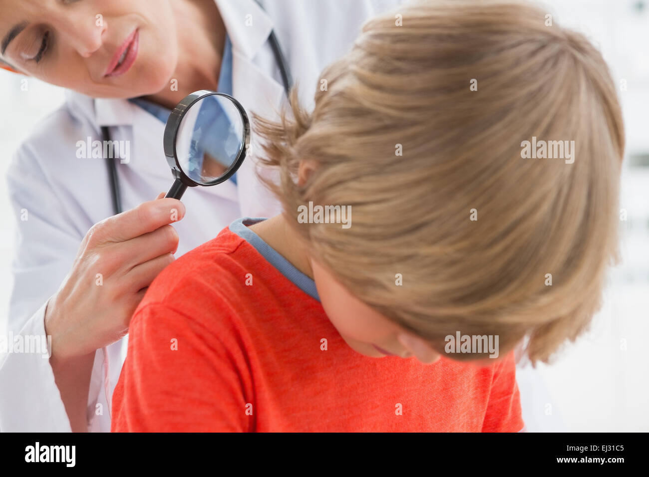 Doctor examining patient with magnifying glass Stock Photo - Alamy