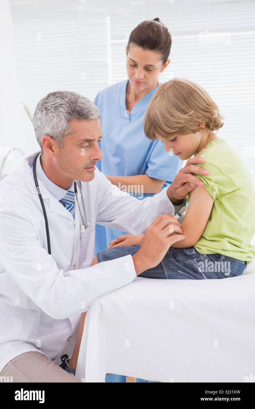 Doctor doing injection at little boy Stock Photo - Alamy