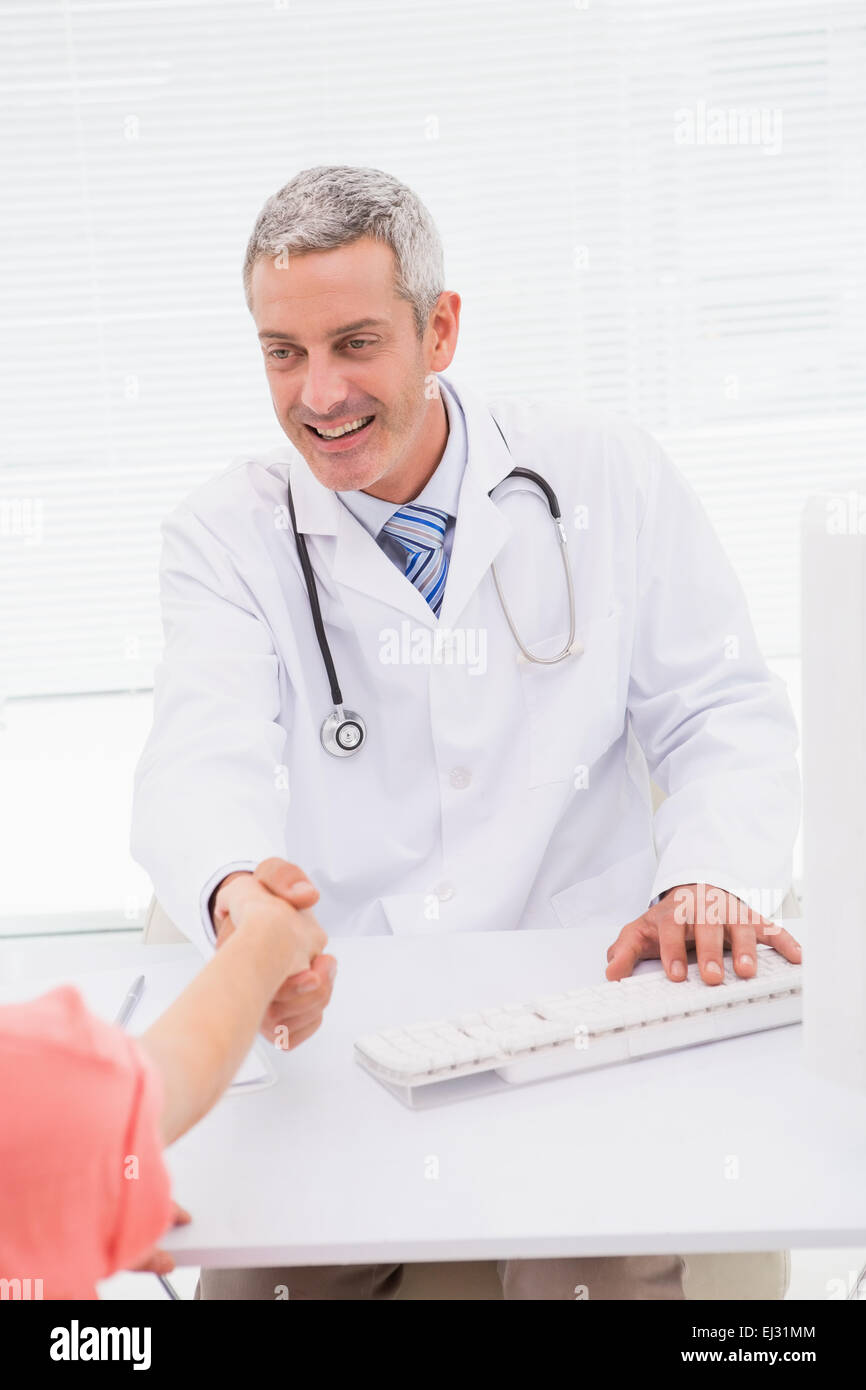 Happy doctor handshake at his patient Stock Photo - Alamy