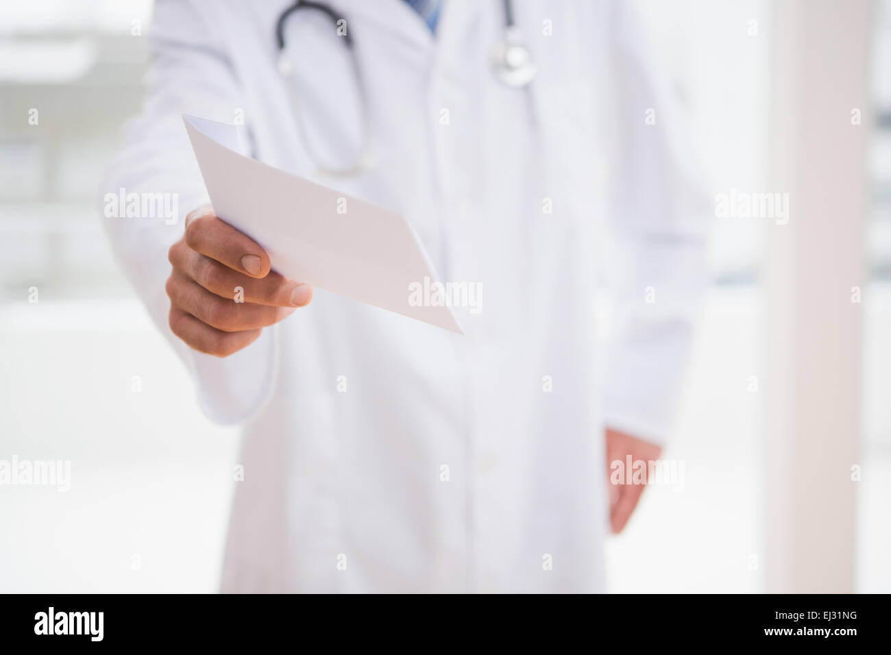 Doctor giving a paper Stock Photo - Alamy