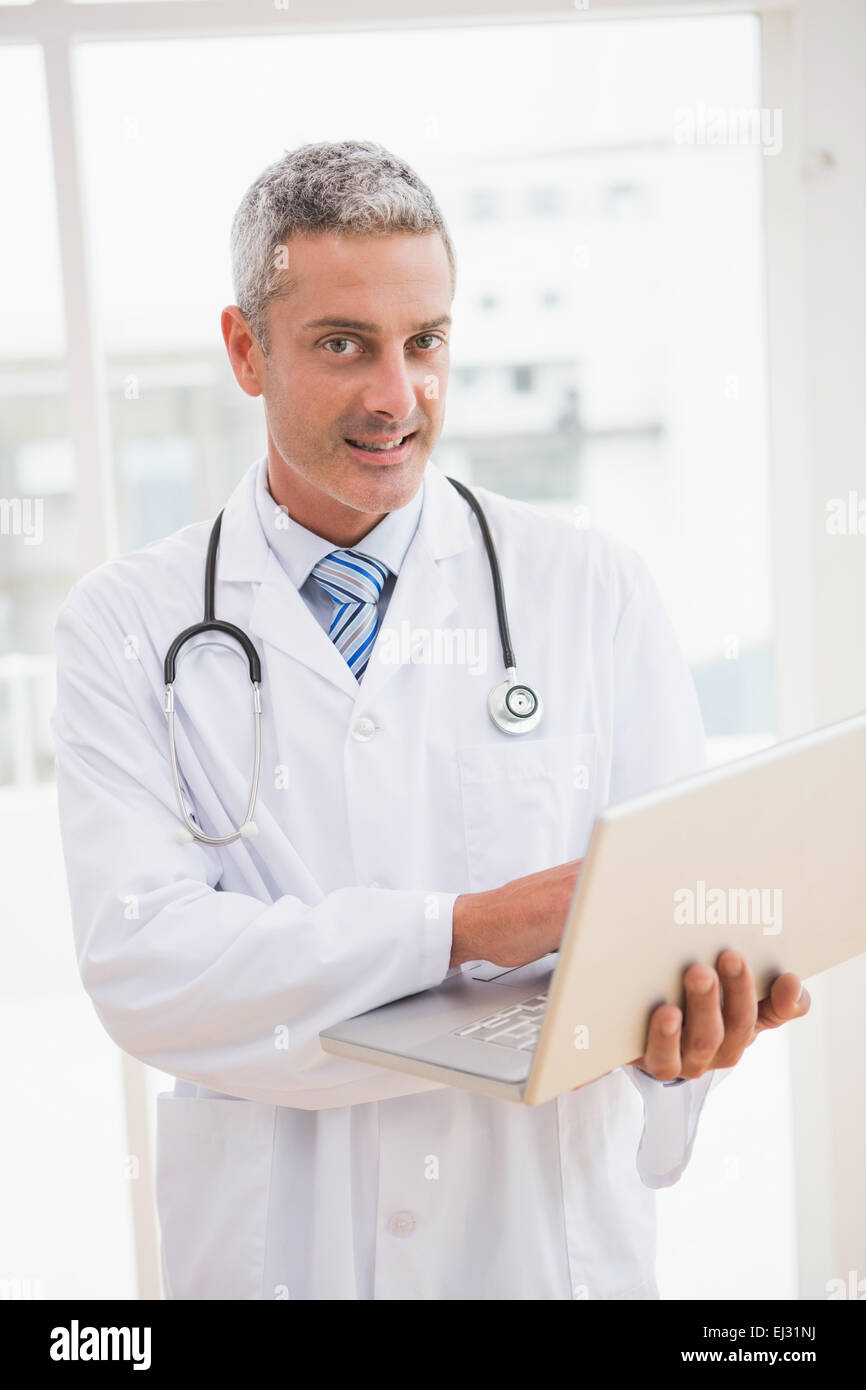 Doctor stethoscope holding laptop typing hi-res stock photography and ...
