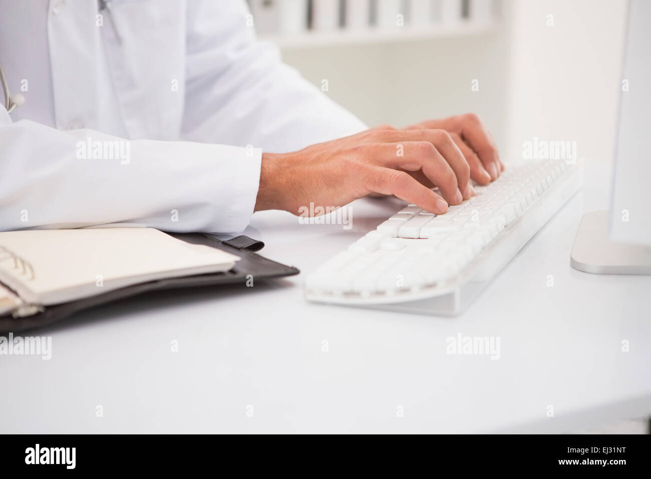 Doctor typing on keyboard and Stock Photo - Alamy