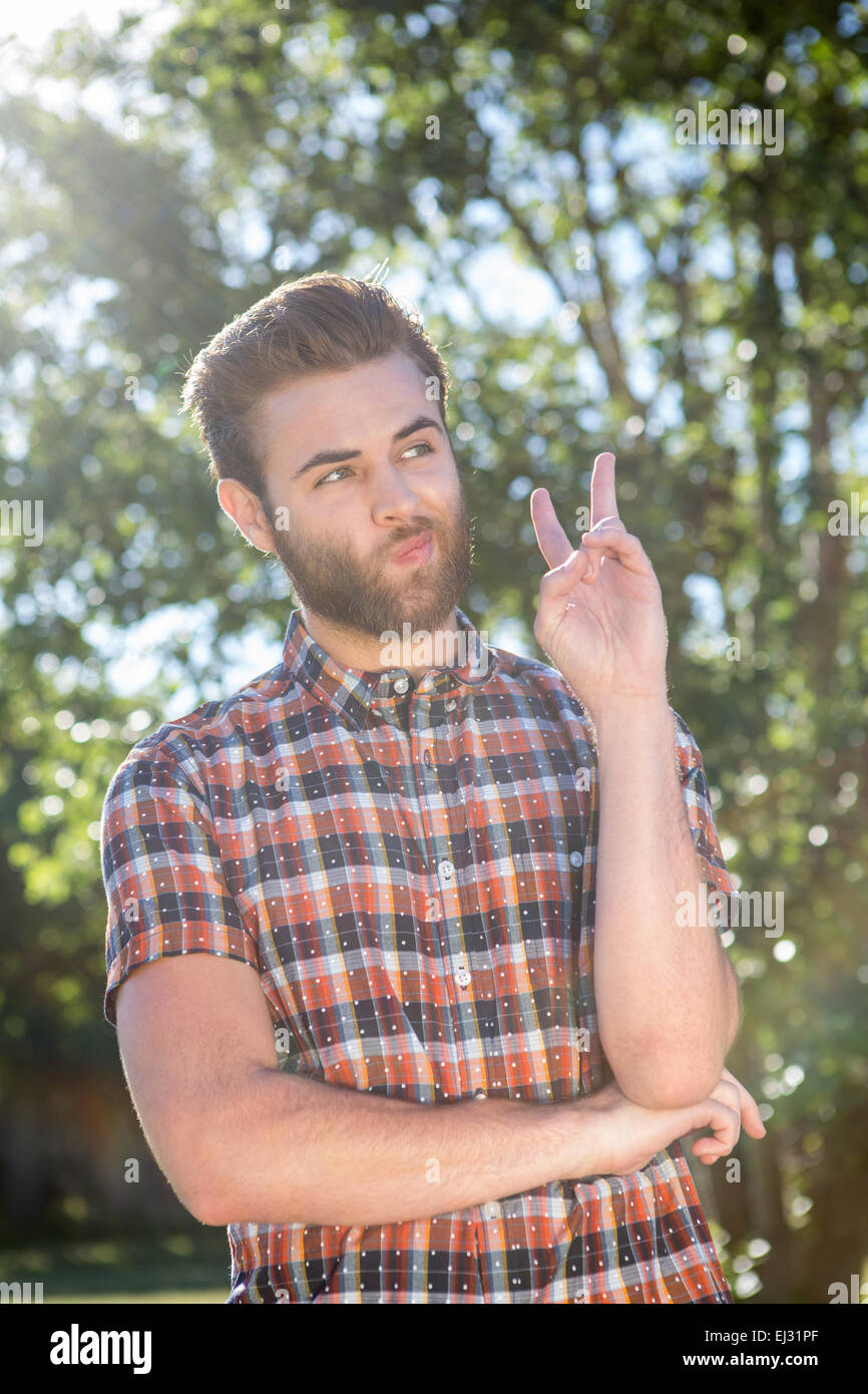 Happy hipster showing peace sign Stock Photo - Alamy