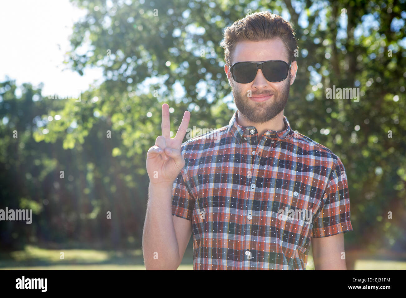 Handsome hipster smiling at camera Stock Photo - Alamy