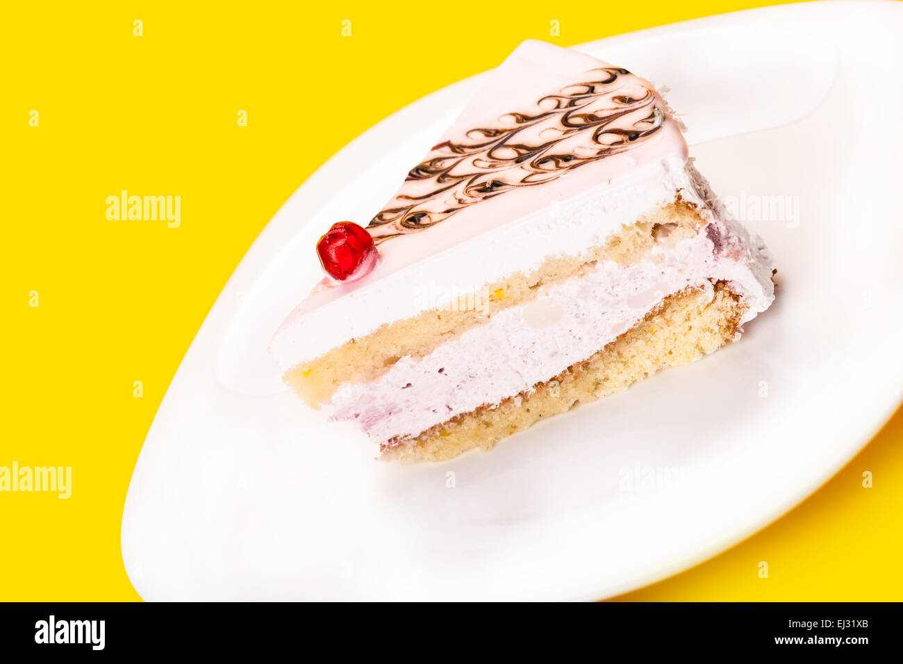 piece of vanilla cake on a yellow background Stock Photo - Alamy