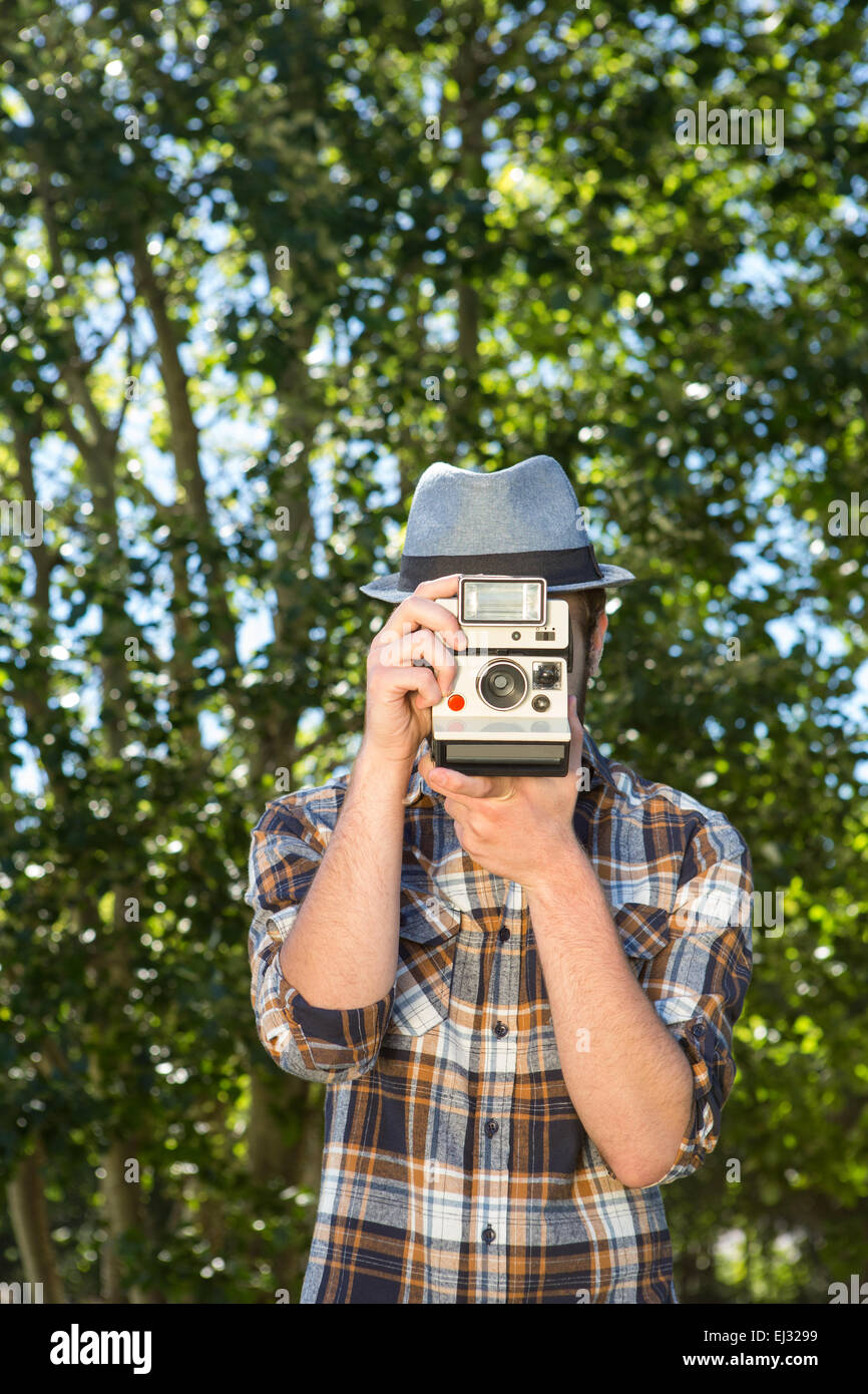 Handsome hipster using vintage camera Stock Photo - Alamy