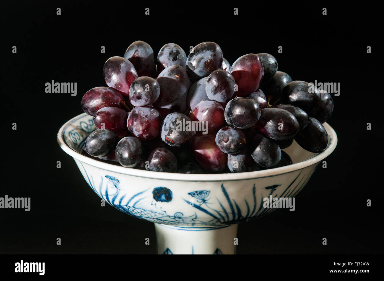 Ming Dynasty Chinese bowl of black grapes in studio setting Stock Photo ...