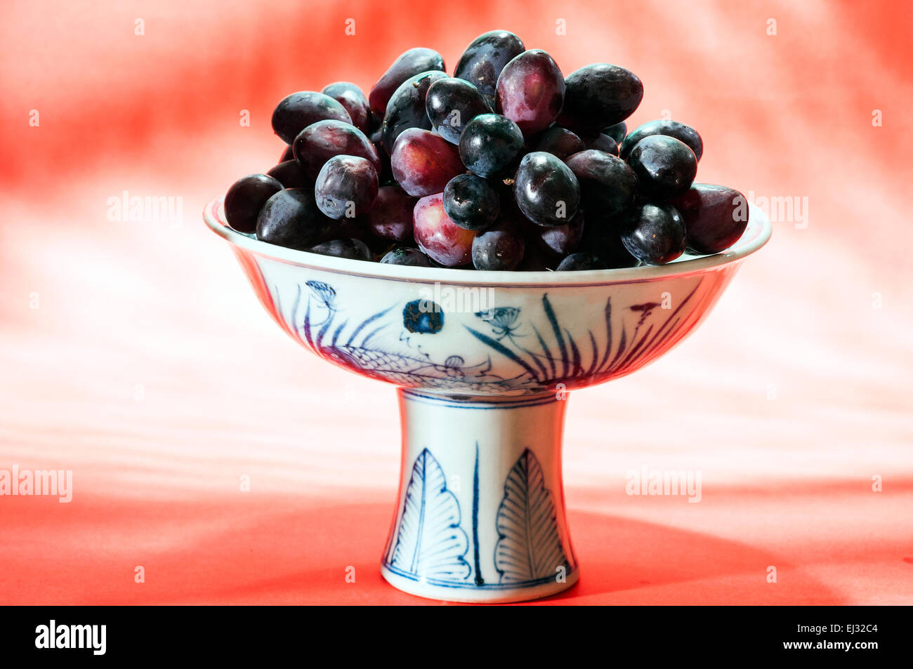 Ming Dynasty Chinese bowl of black grapes in studio setting Stock Photo ...