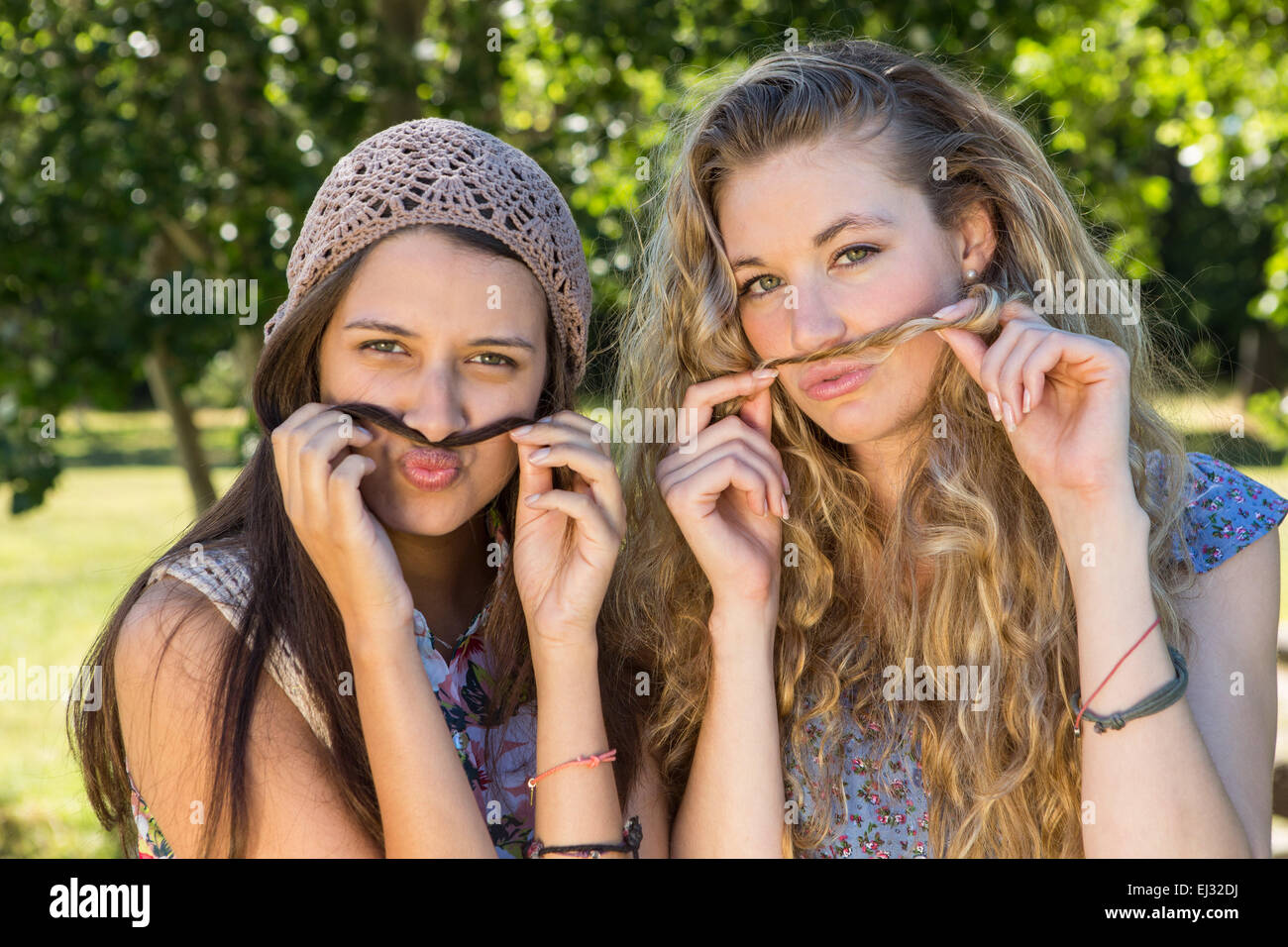 Pretty friends smiling at camera Stock Photo - Alamy