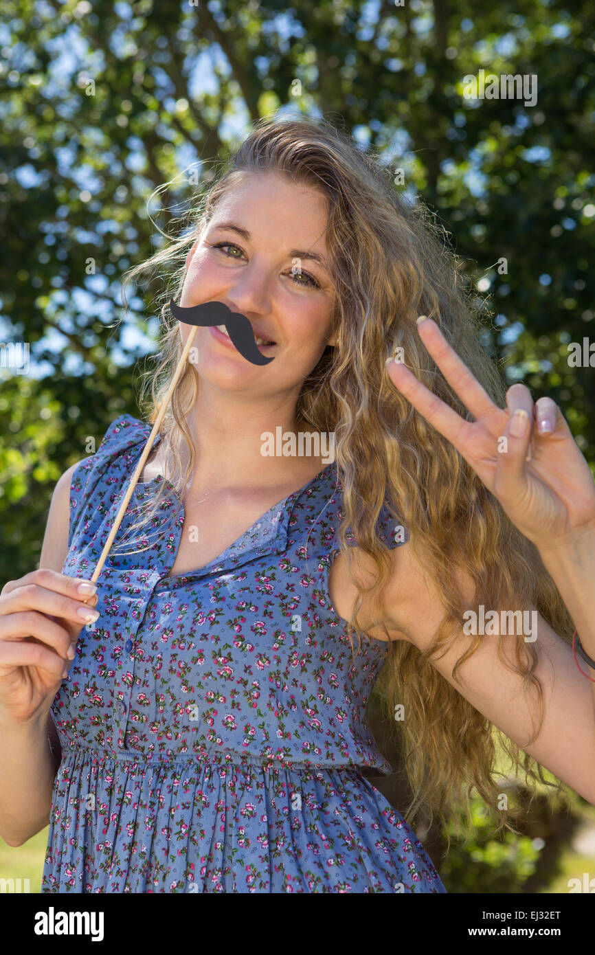 Pretty blonde with fake mustache Stock Photo - Alamy