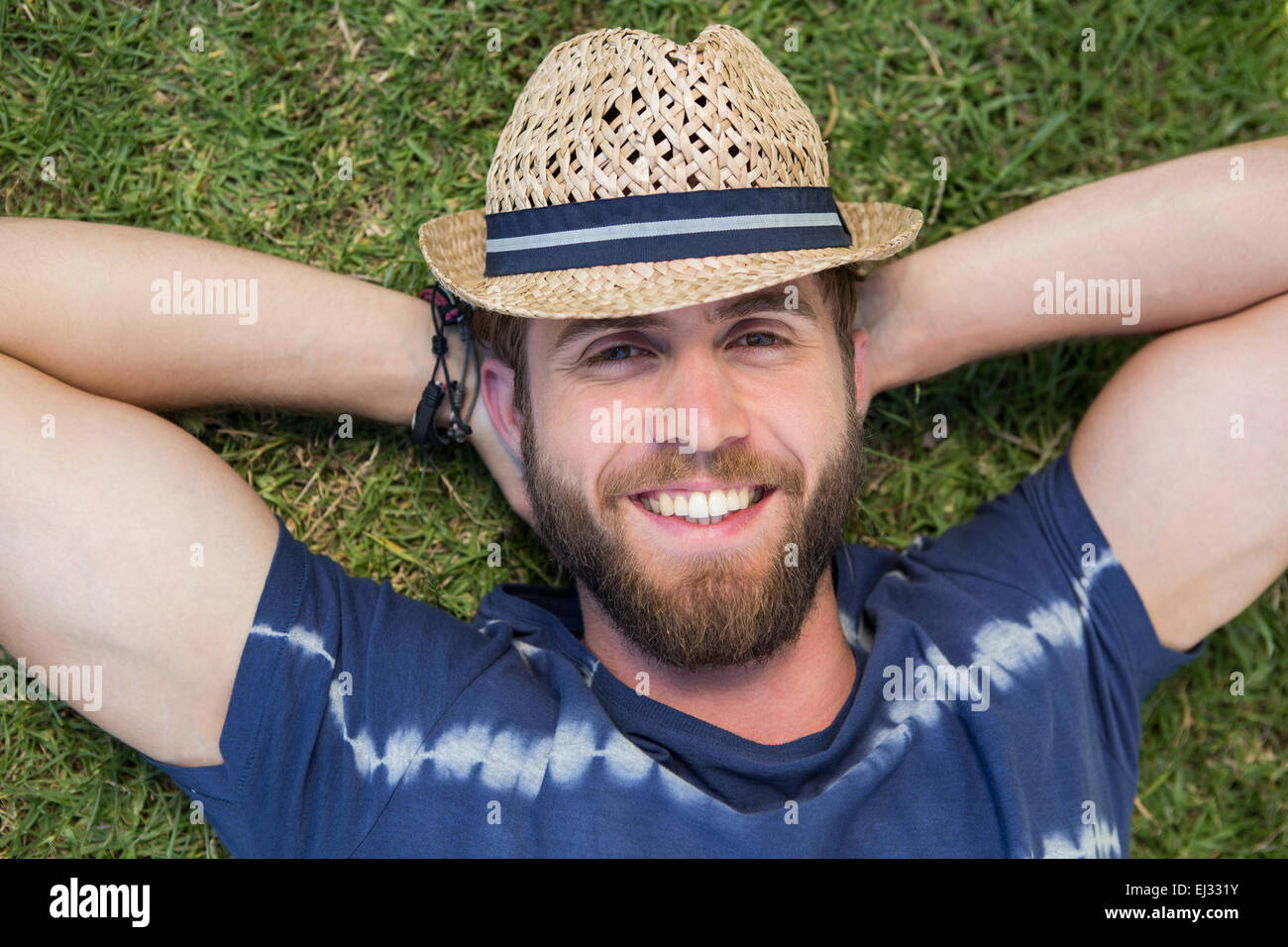Handsome hipster lying on grass Stock Photo - Alamy