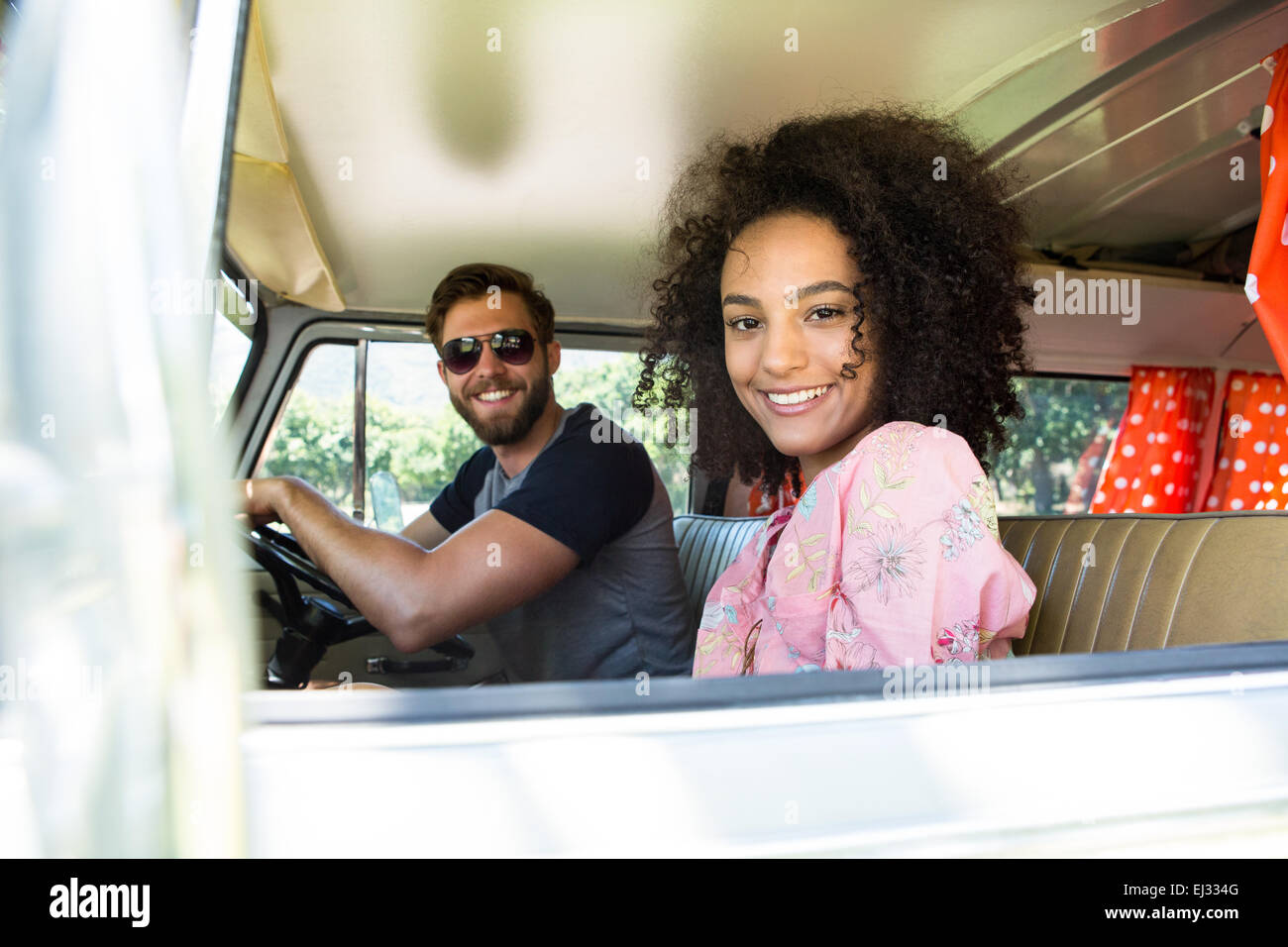 Hipster couple driving in camper van Stock Photo - Alamy