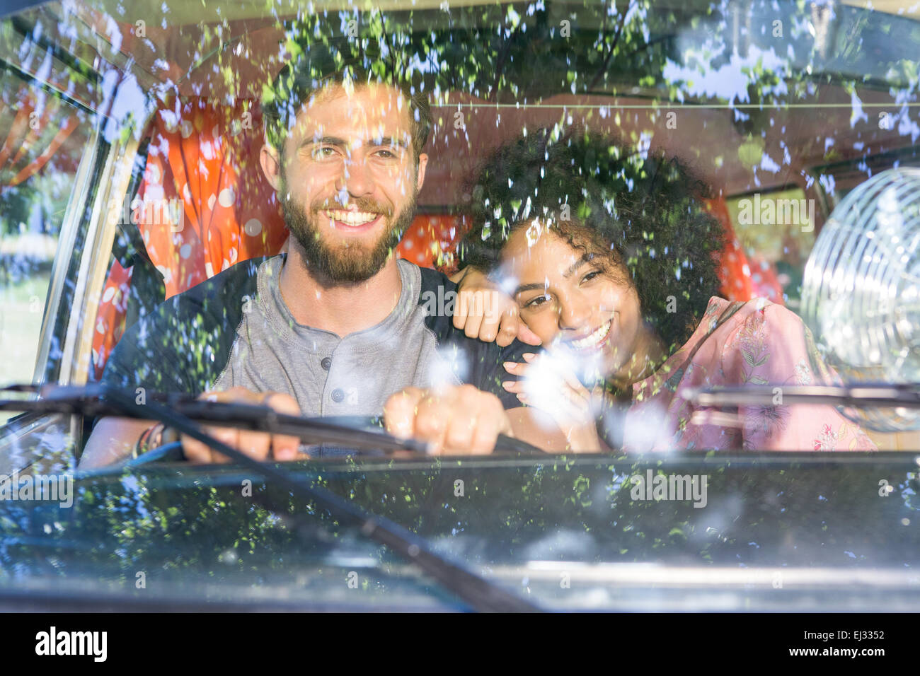 Hipster couple driving in camper van Stock Photo - Alamy
