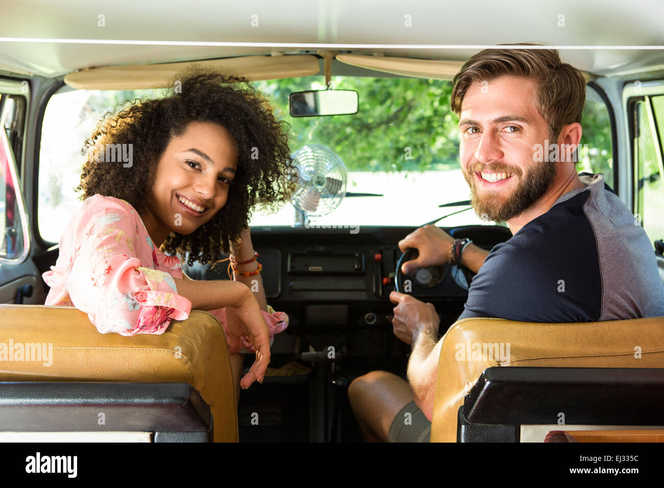 Hipster couple driving in camper van Stock Photo - Alamy