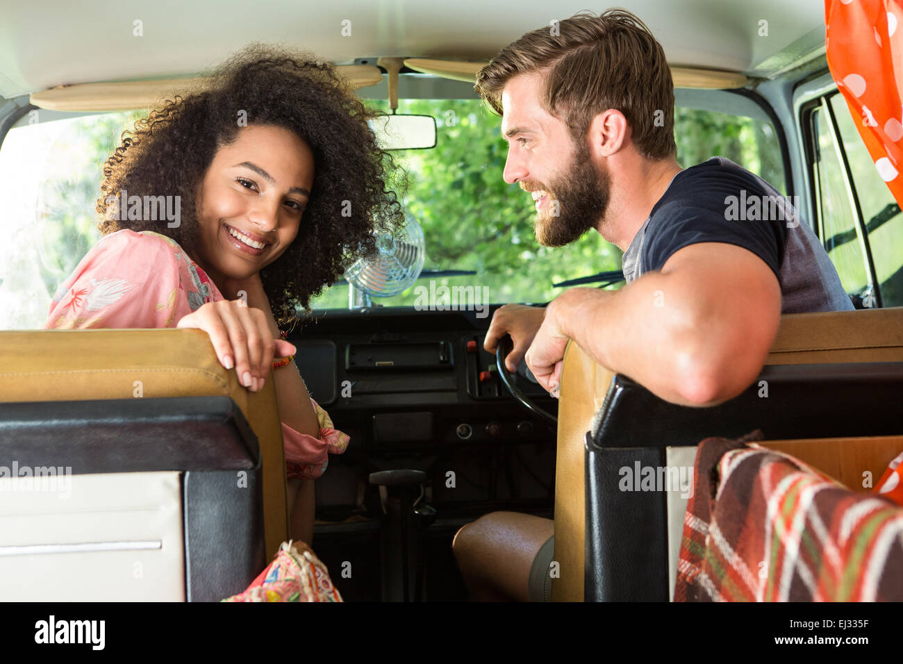 Hipster couple driving in camper van Stock Photo - Alamy