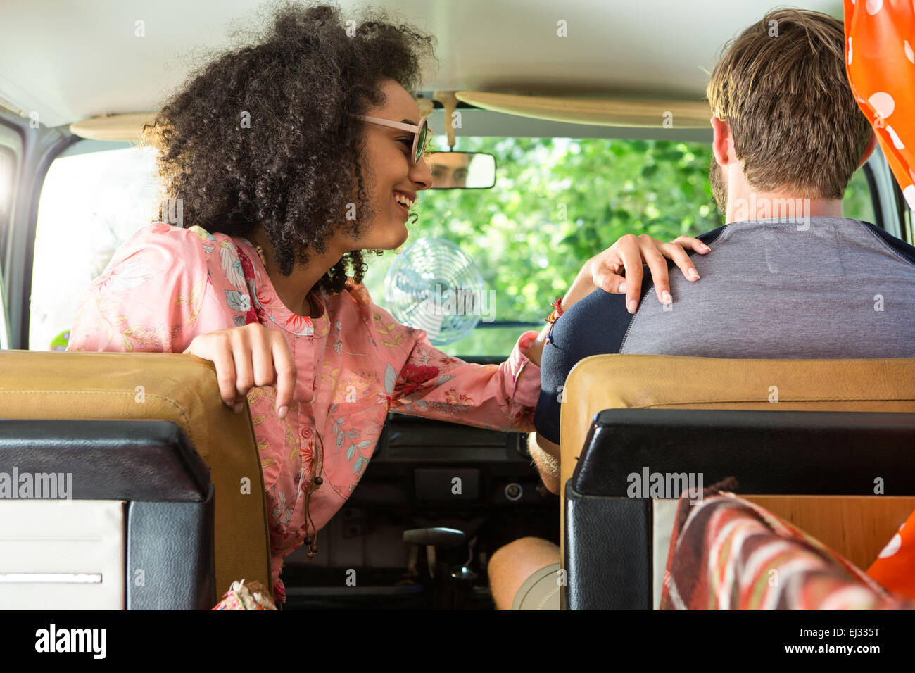 Hipster couple driving in camper van Stock Photo - Alamy