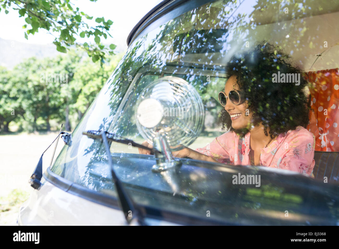 Pretty hipster driving camper van Stock Photo - Alamy