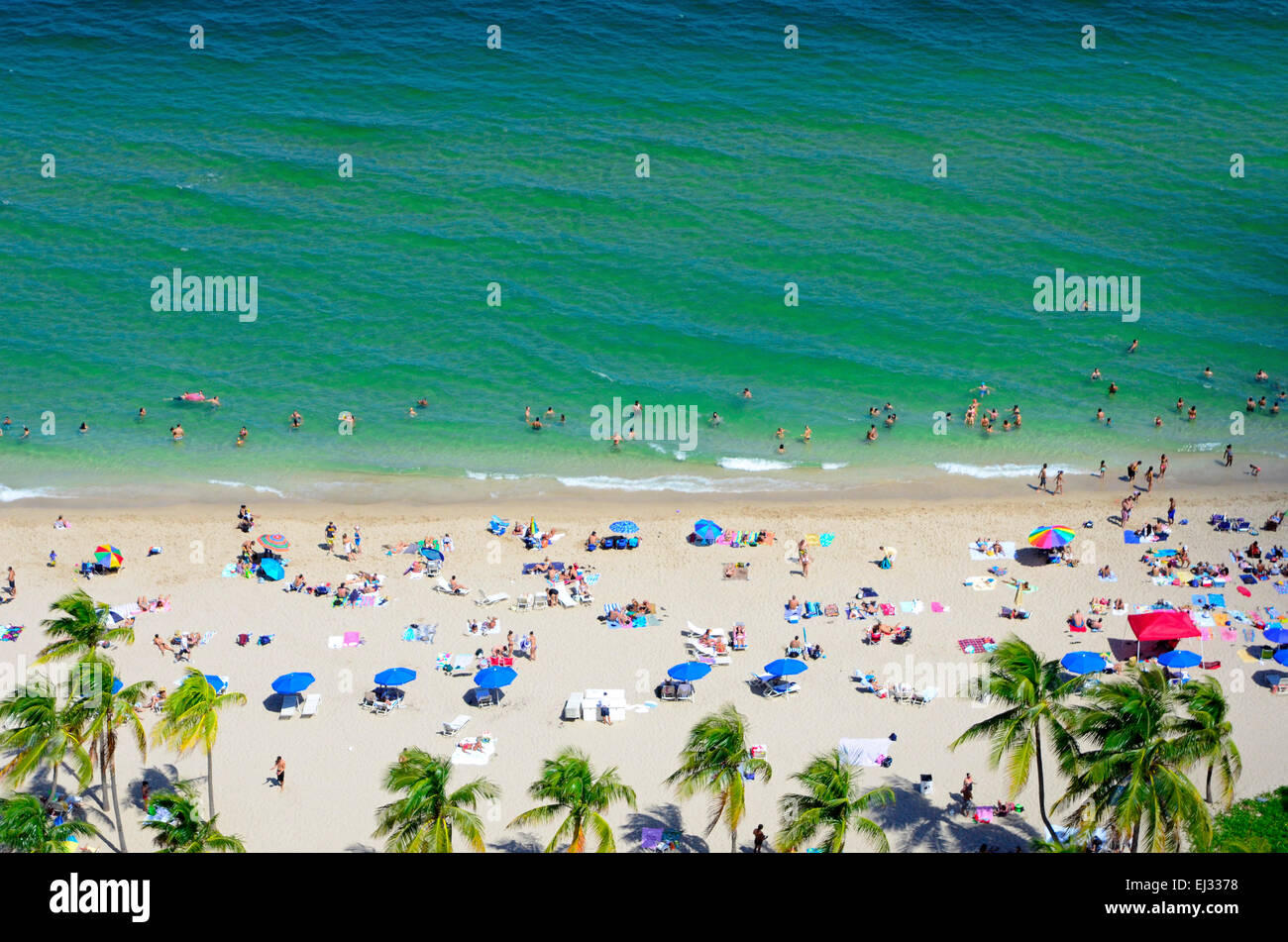 Overhead view of sunbathers lining the beach to soak up the sun and fun ...