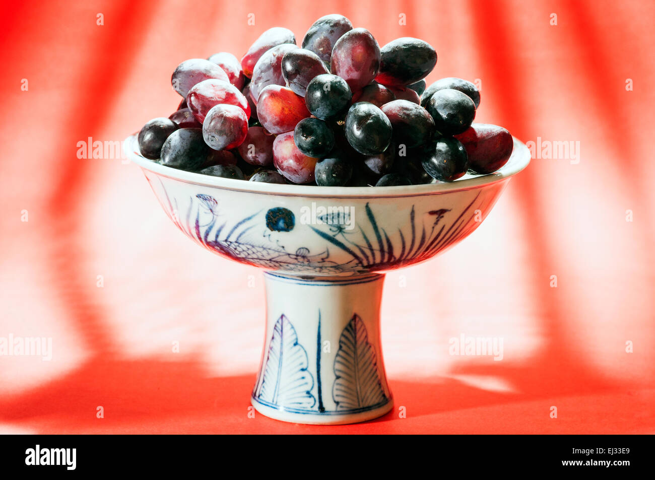 Ming Dynasty Chinese bowl of black grapes in studio setting Stock Photo ...
