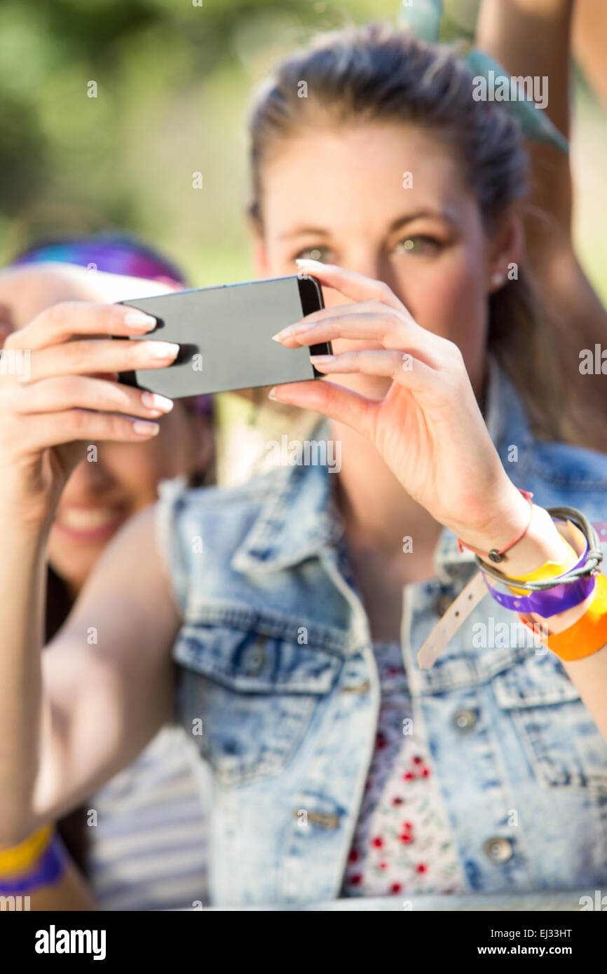 Excited music fan taking photo Stock Photo - Alamy