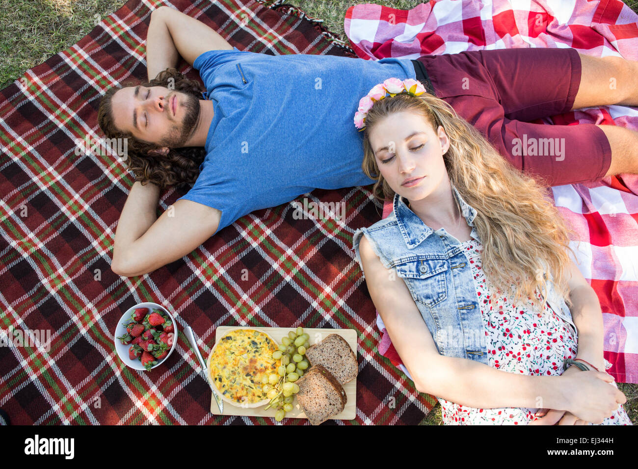 Cute couple having a picnic Stock Photo - Alamy