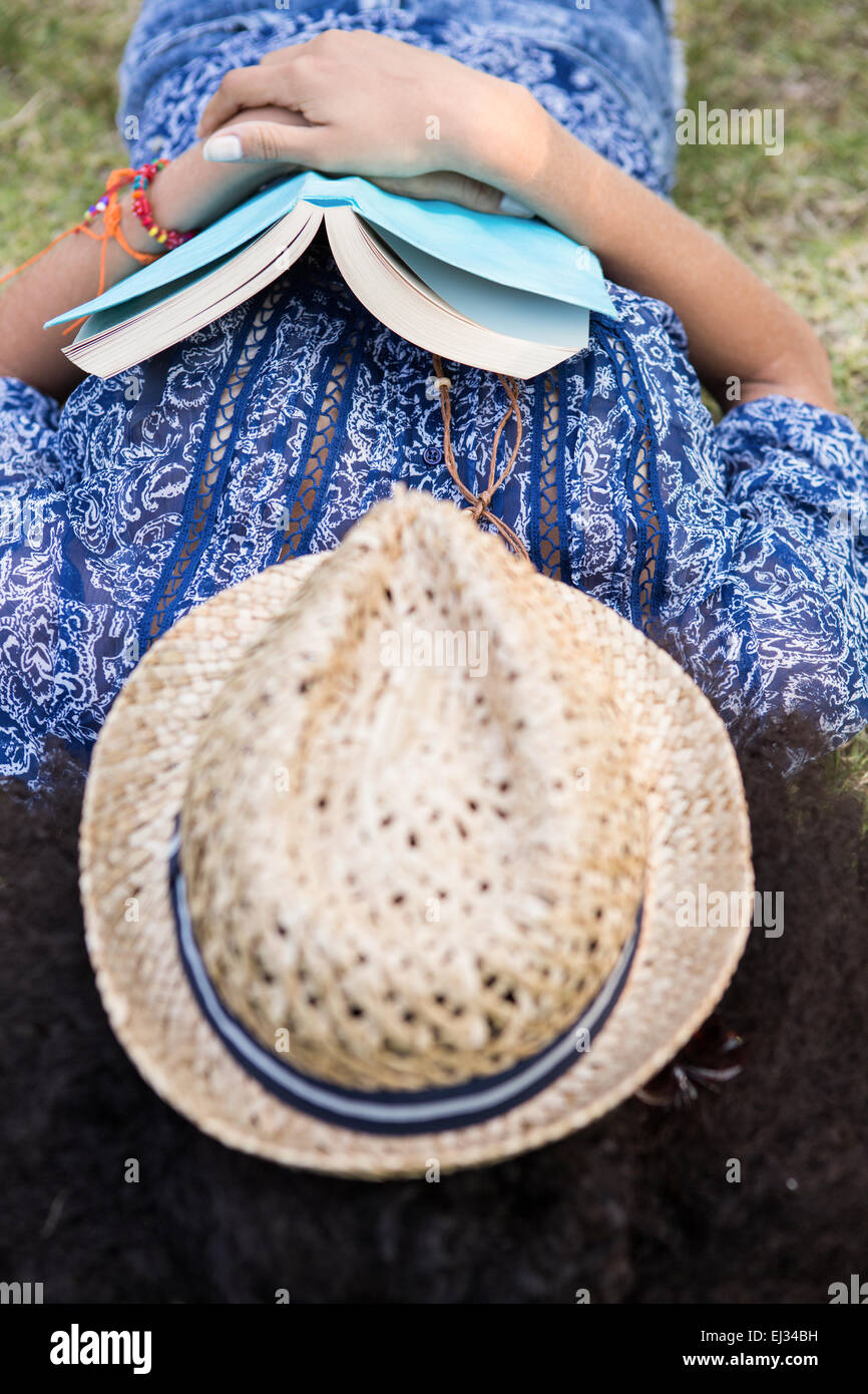 Woman covering face hat lying hi-res stock photography and images - Alamy