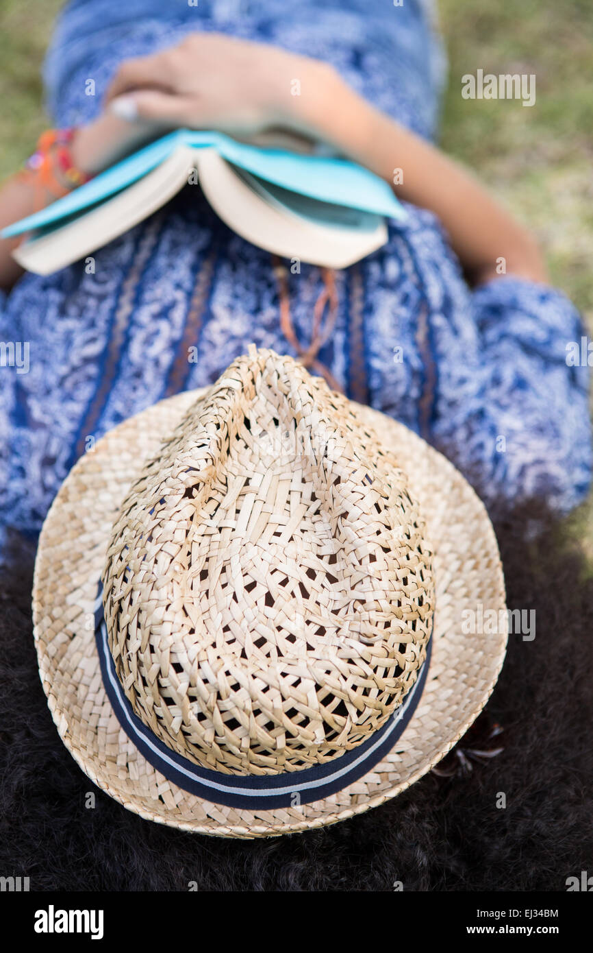 Woman covering face hat lying hi-res stock photography and images - Alamy