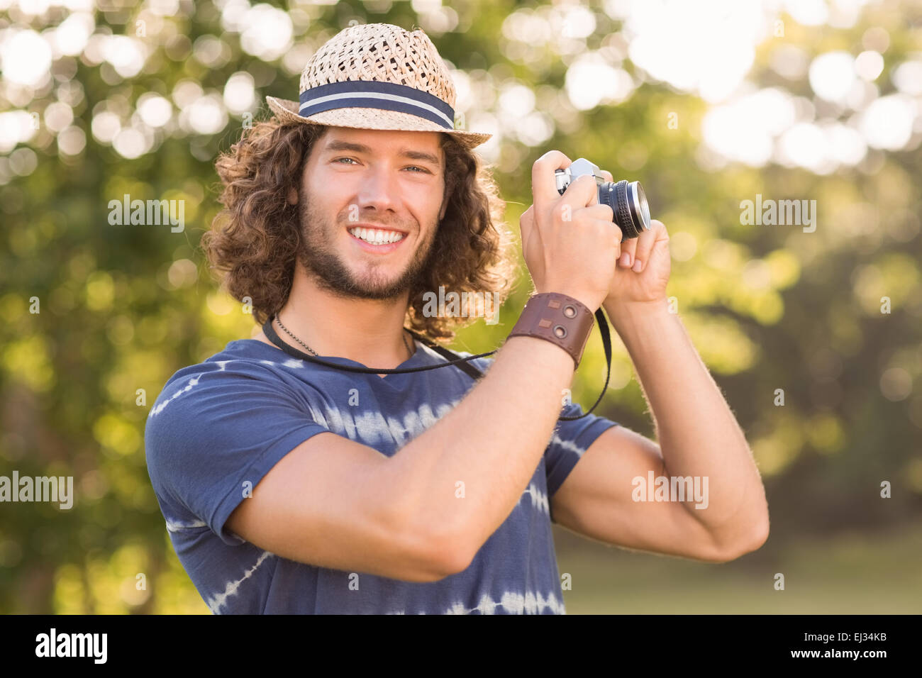 Handsome hipster using vintage camera Stock Photo - Alamy