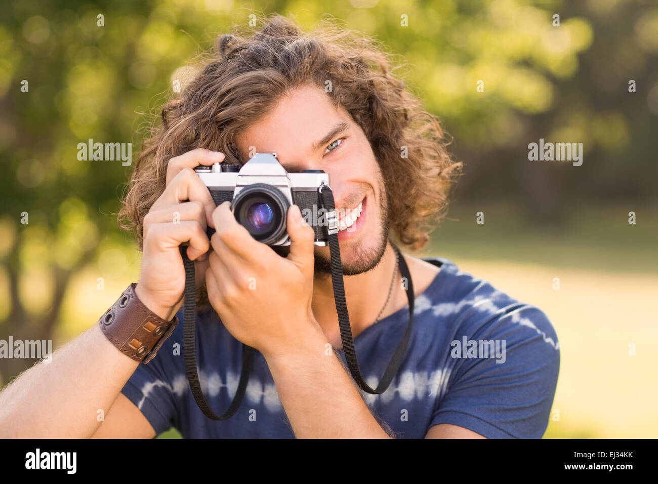 Handsome hipster using vintage camera Stock Photo - Alamy