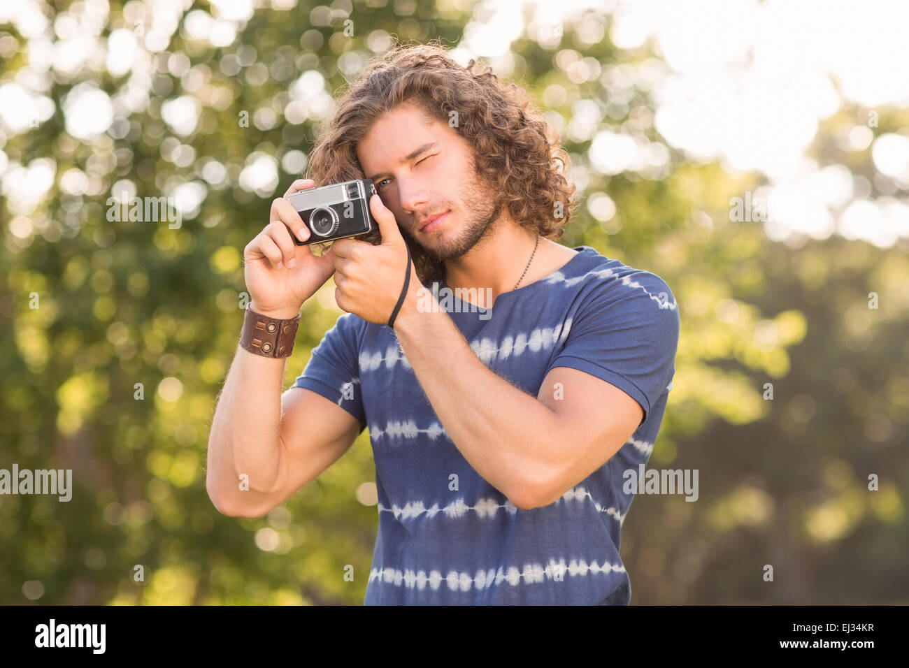 Handsome hipster using vintage camera Stock Photo - Alamy